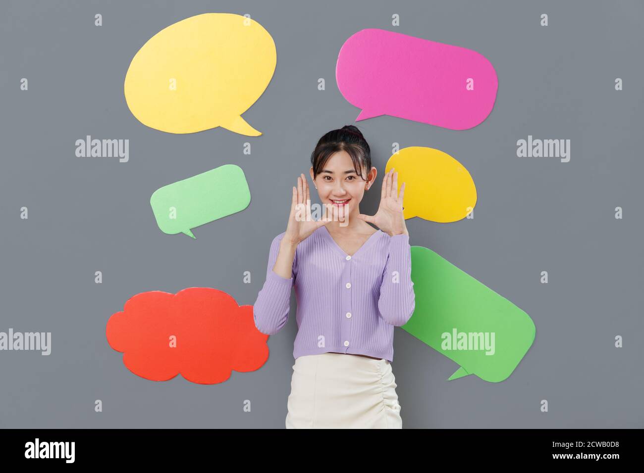 Happy girl standing in front of the dialog box Stock Photo - Alamy