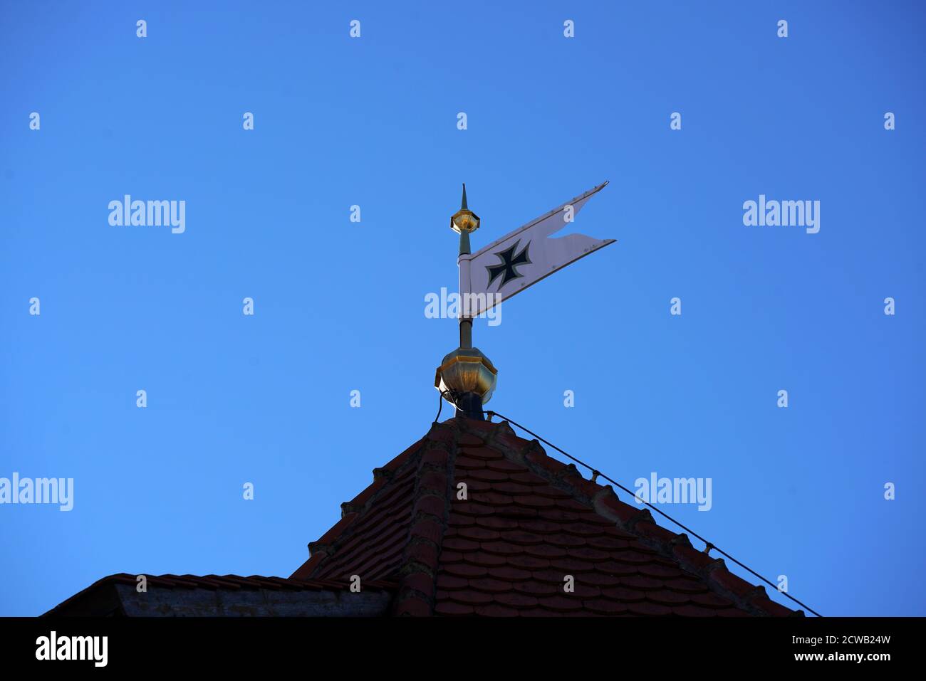Low angle shot of a building roof flag with a cross Stock Photo - Alamy