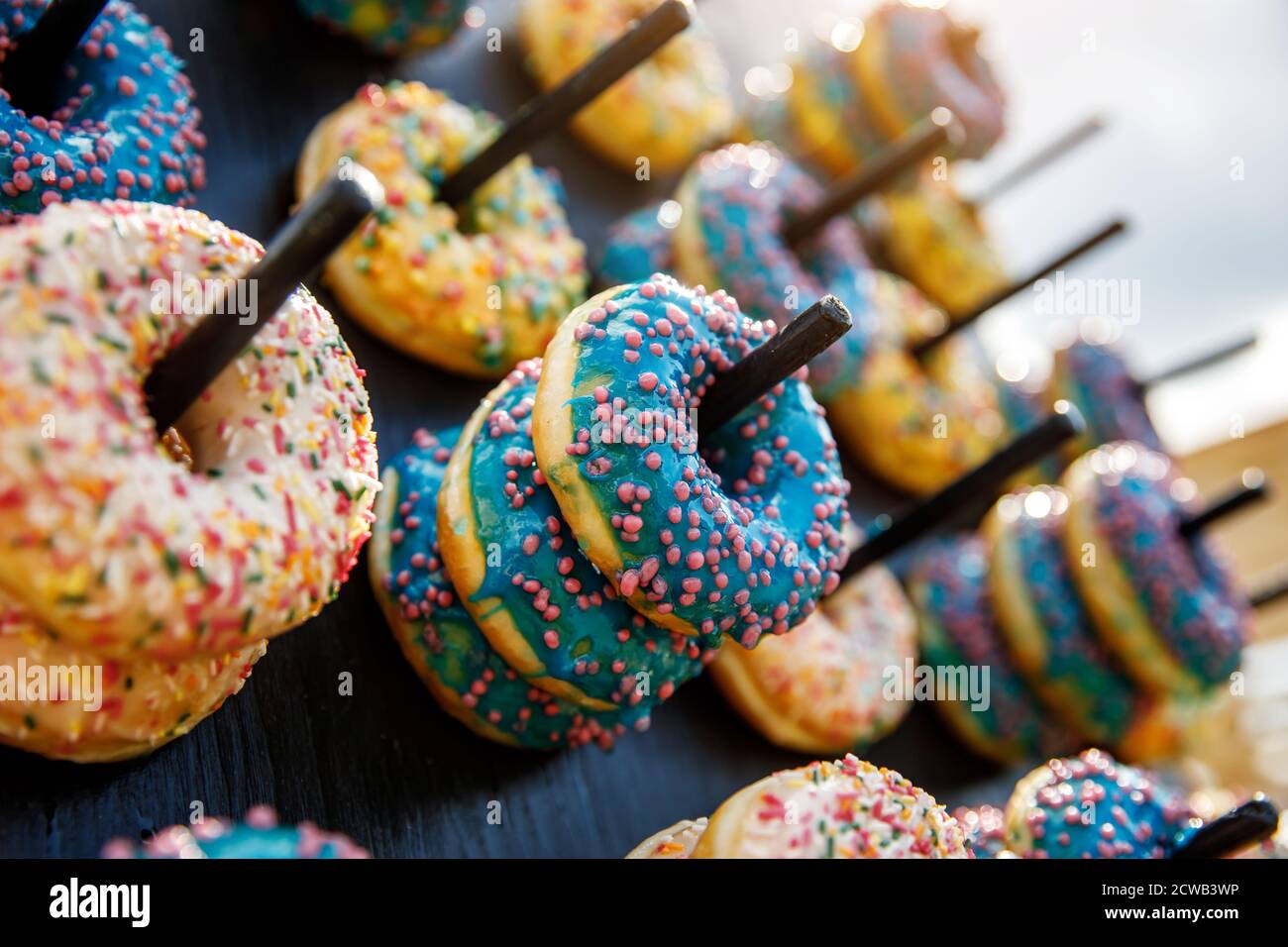 Assorted donuts on a wand. Dessert colorful snack Stock Photo - Alamy