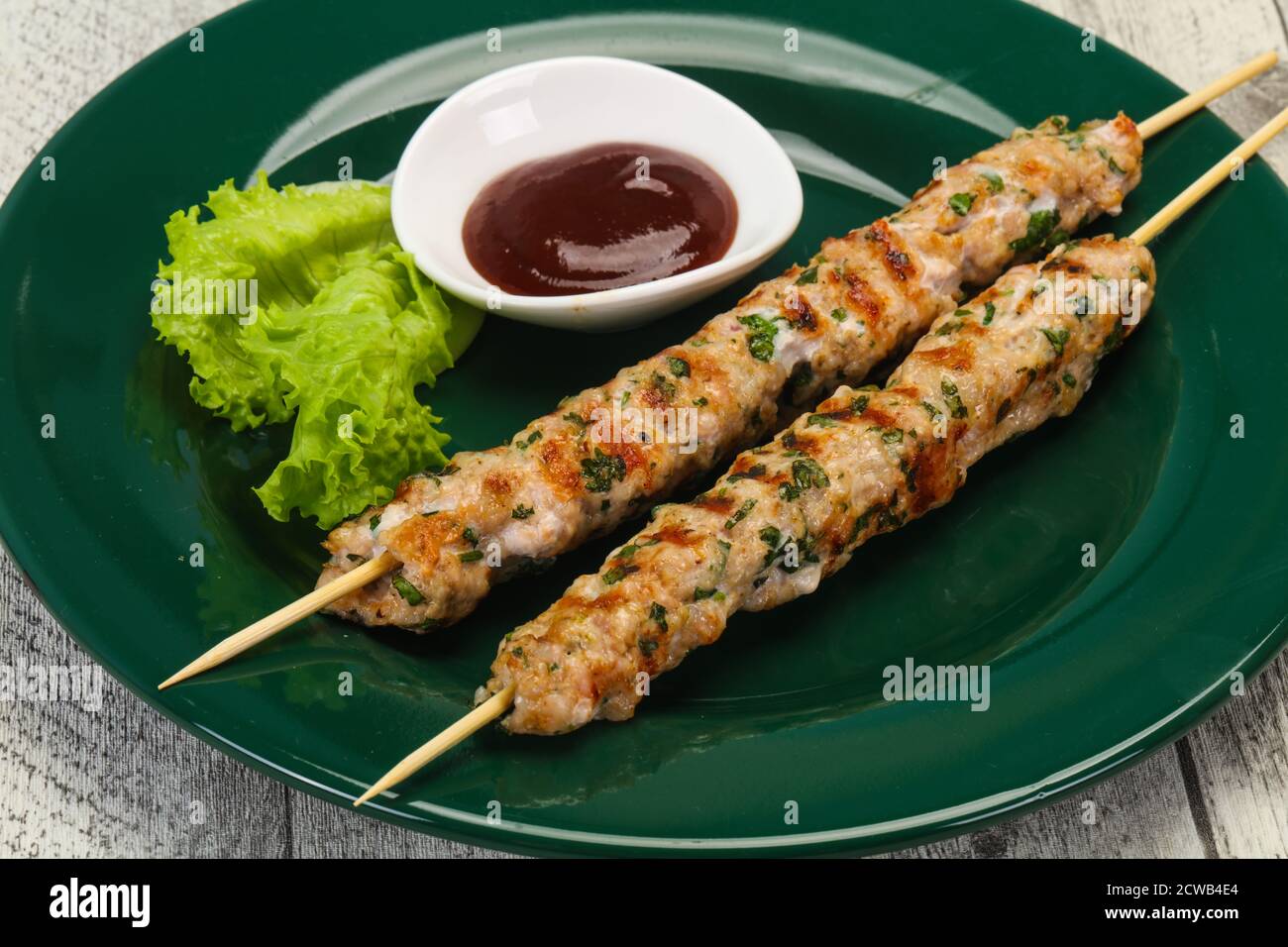 Minced pork skewer kebab with bbq sauce Stock Photo - Alamy