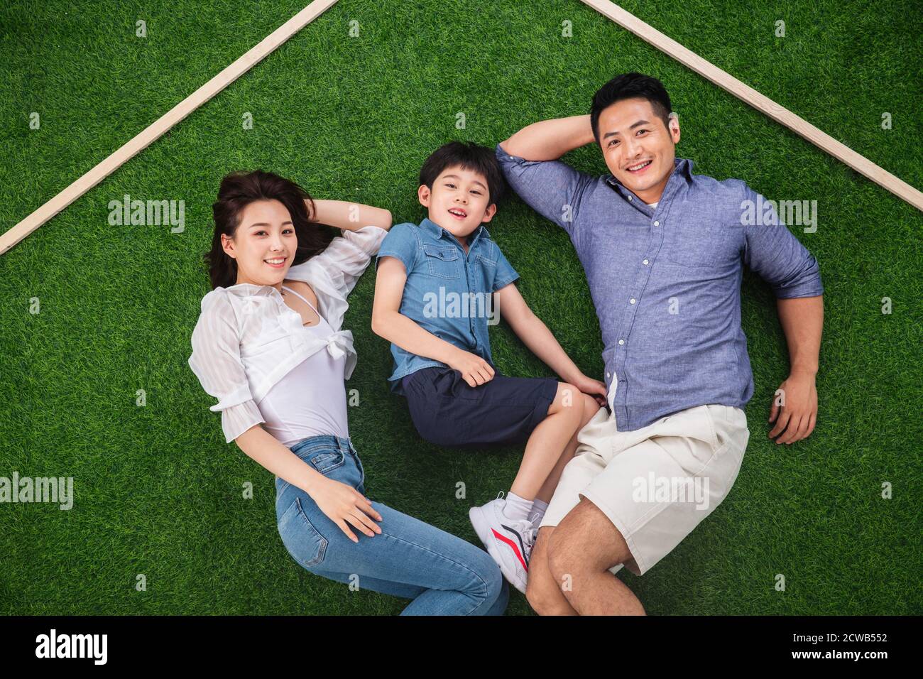 Happy house outline three lay on the grass Stock Photo - Alamy