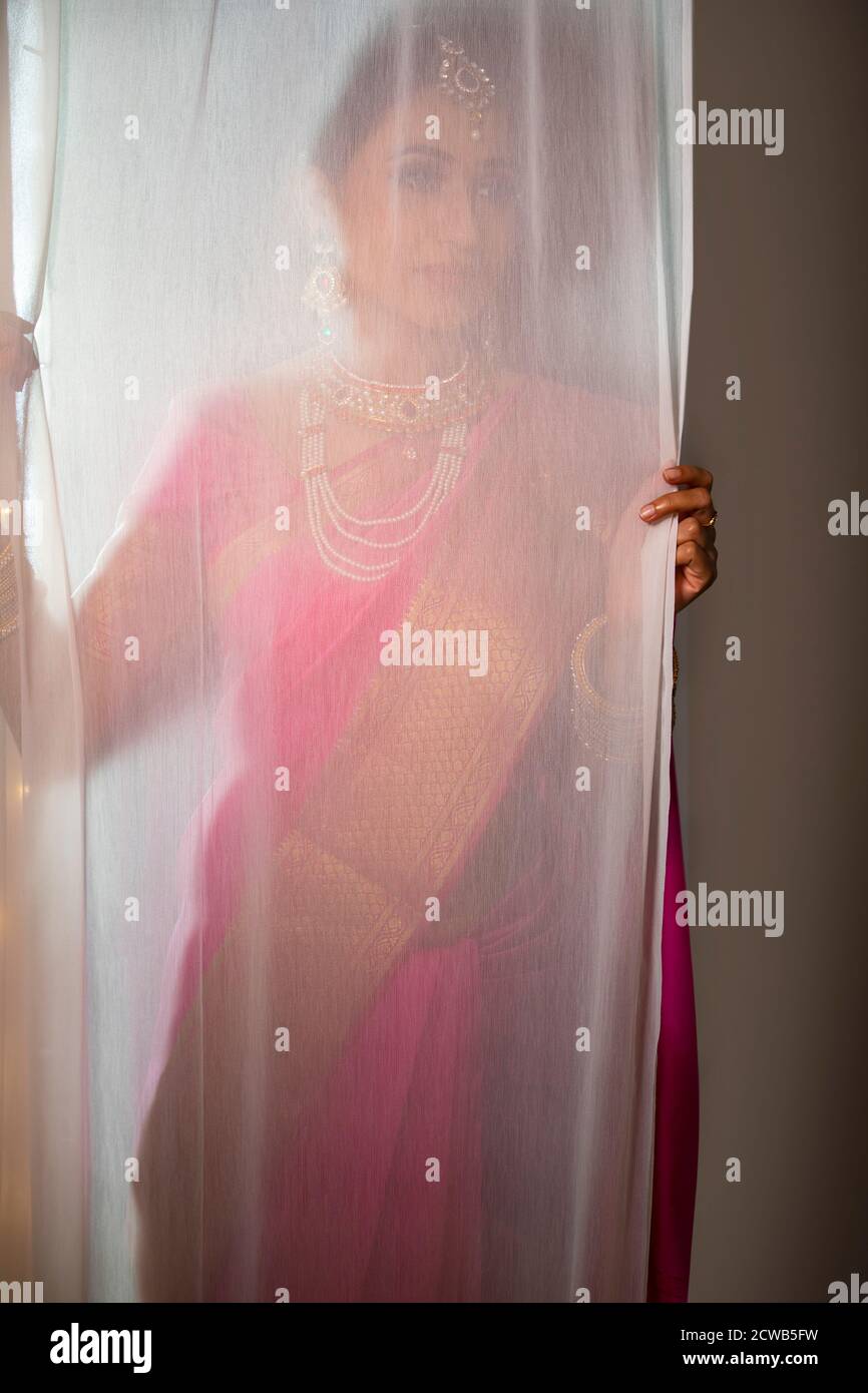 Woman hiding behind curtain hi-res stock photography and images - Alamy