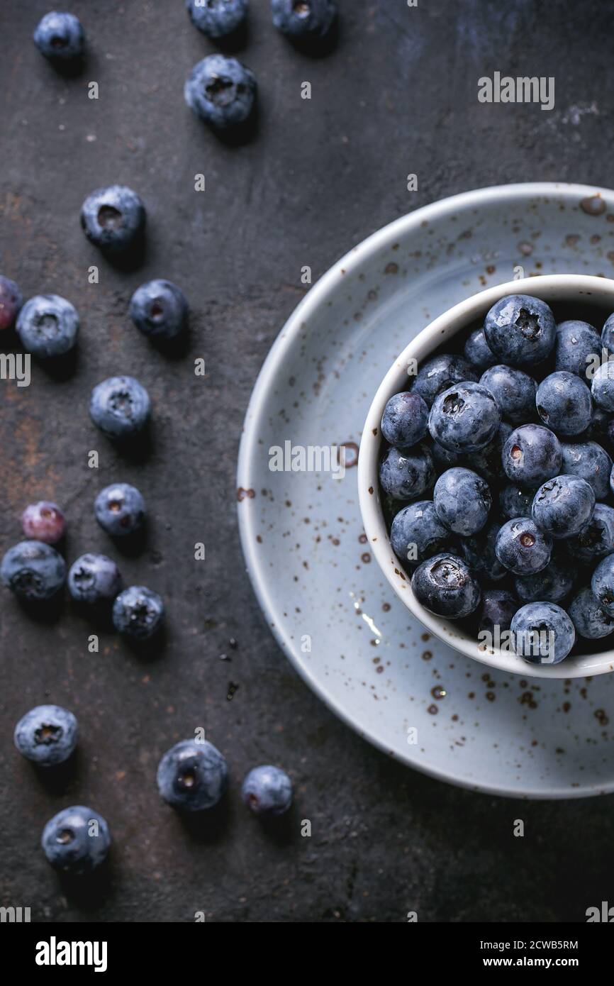Cup of blueberries at black surface. Top view Stock Photo - Alamy
