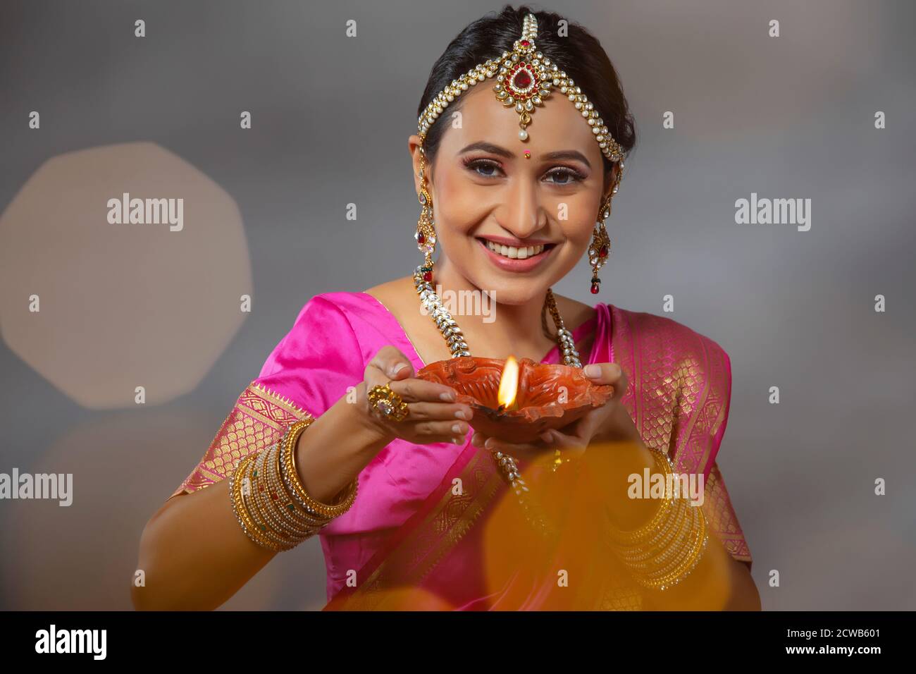 Portrait of a woman holding a diya on the occasion of Diwali Stock ...