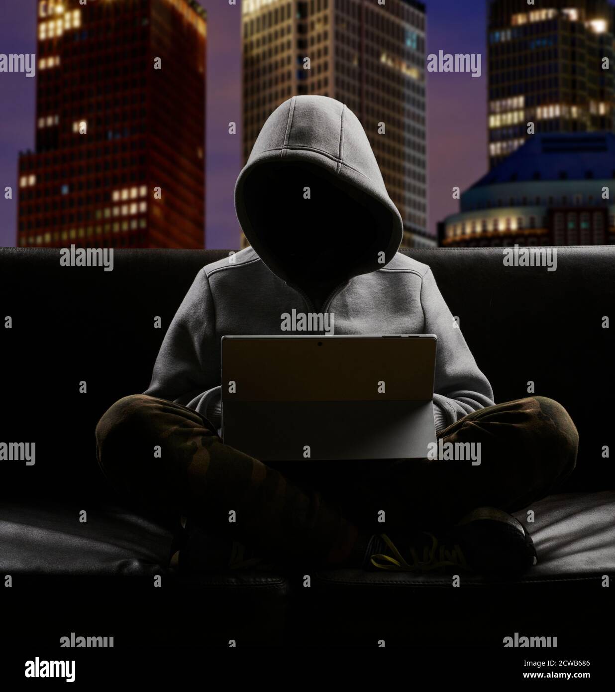 Computer hacker with hoodie behind his computer Stock Photo - Alamy