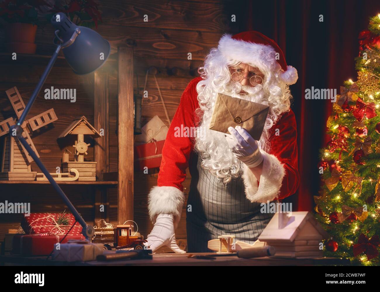 Merry Christmas and Happy Holidays! Santa Clause is preparing gifts for ...