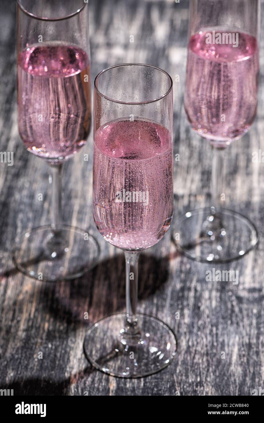 Pink sparkling cocktail with a raspberry Stock Photo - Alamy