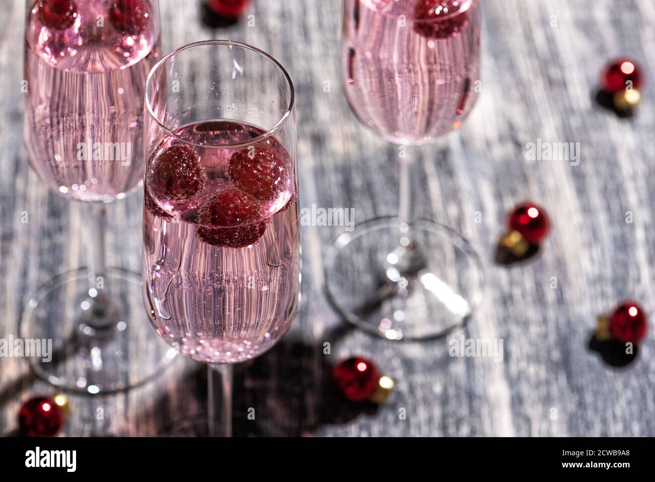 Pink sparkling cocktail with a raspberry Stock Photo - Alamy