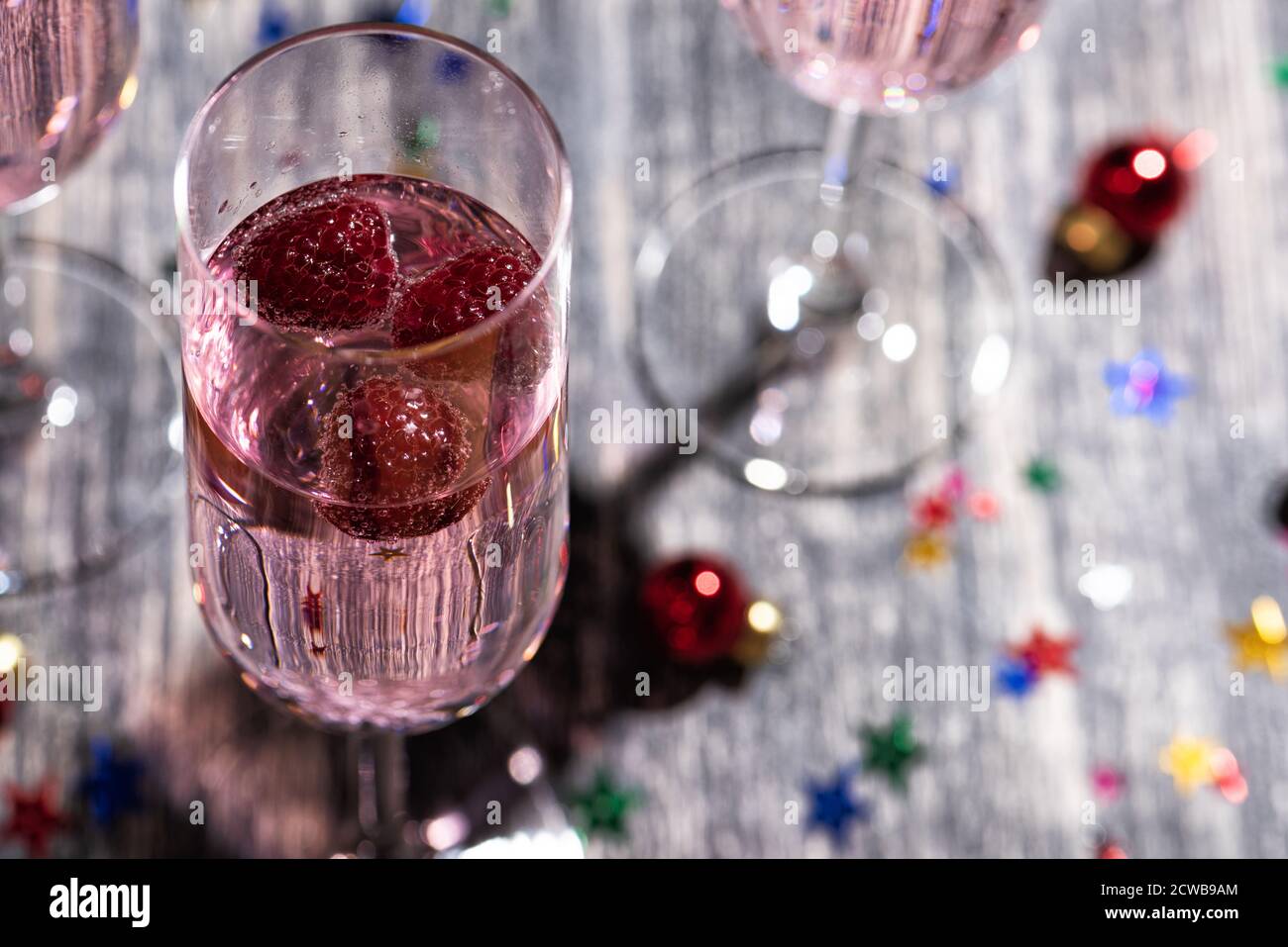 Pink sparkling cocktail with a raspberry Stock Photo - Alamy