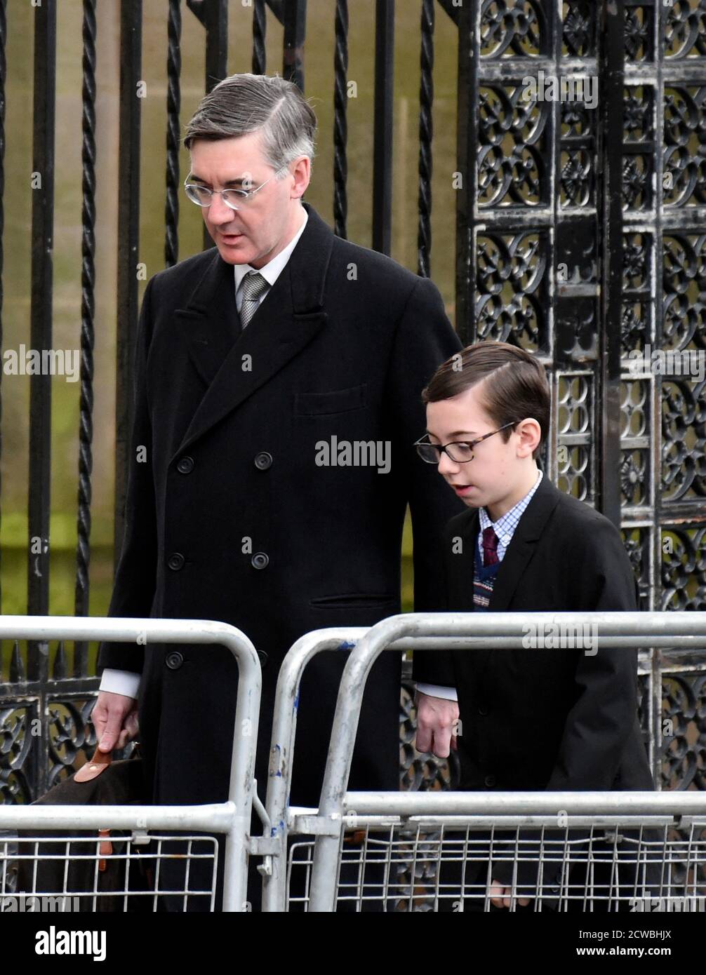 Photograph of Jacob Rees-Mogg with his son, arriving for the state ...
