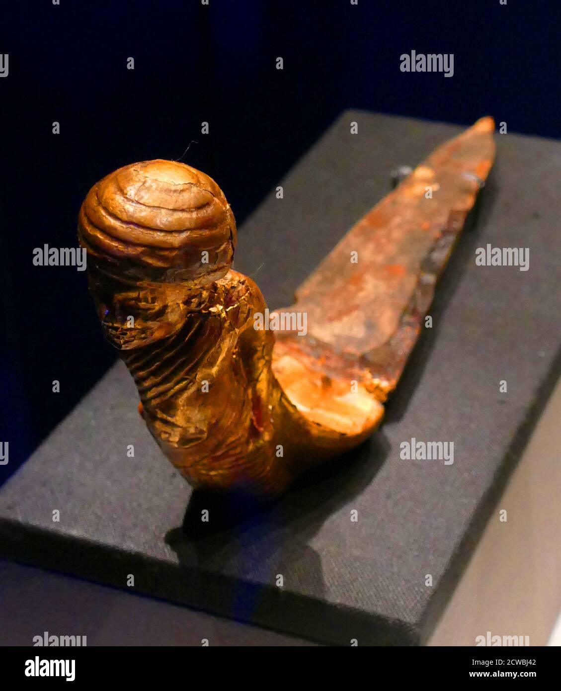 Gilded wooden ceremonial dagger shaped as a captive with his arms tied ...