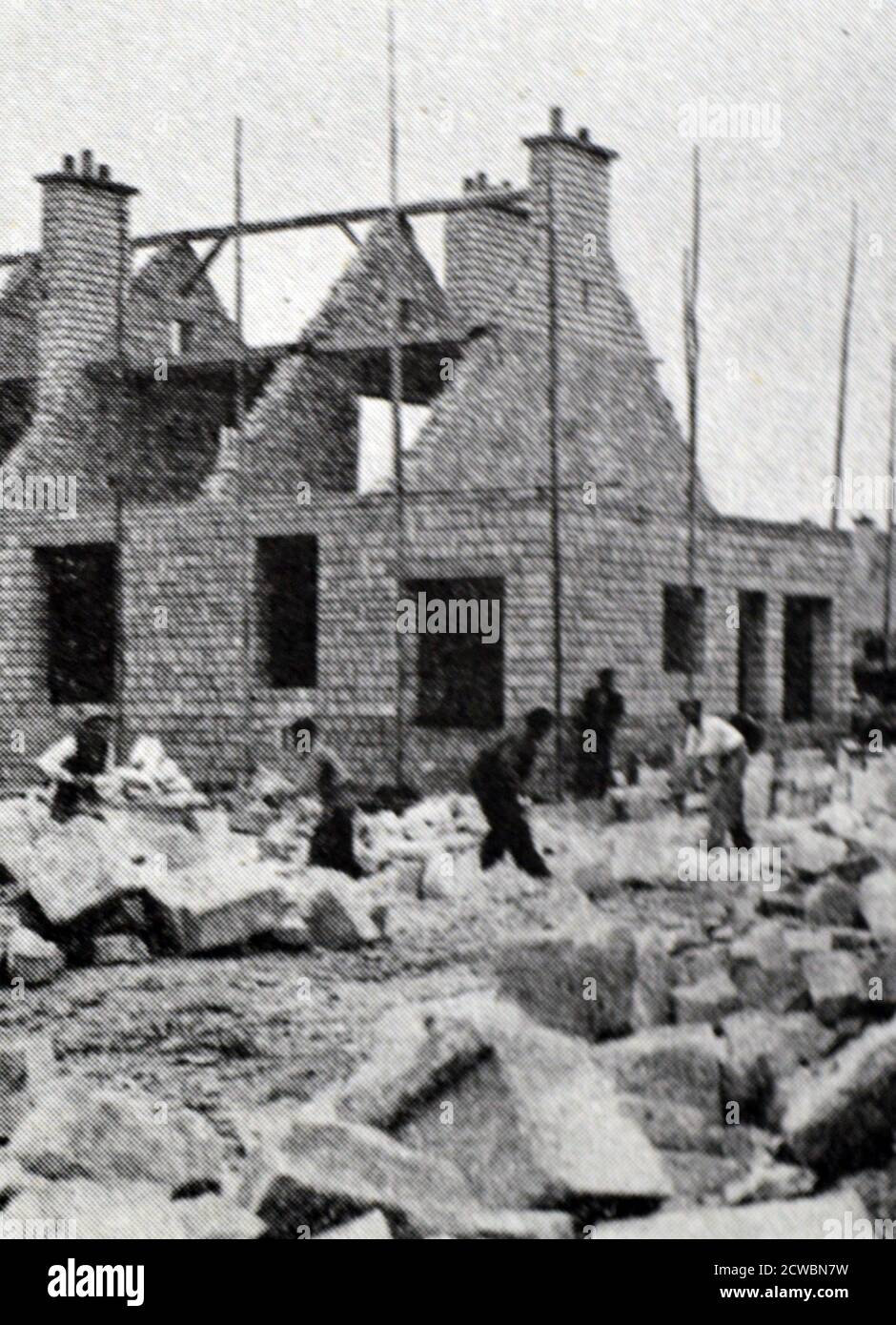 Black and white photograph showing the reconstruction of a destroyed ...