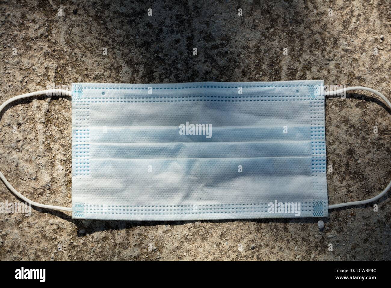 Medical protection mask lost on the ground was used. Disposable mask ...