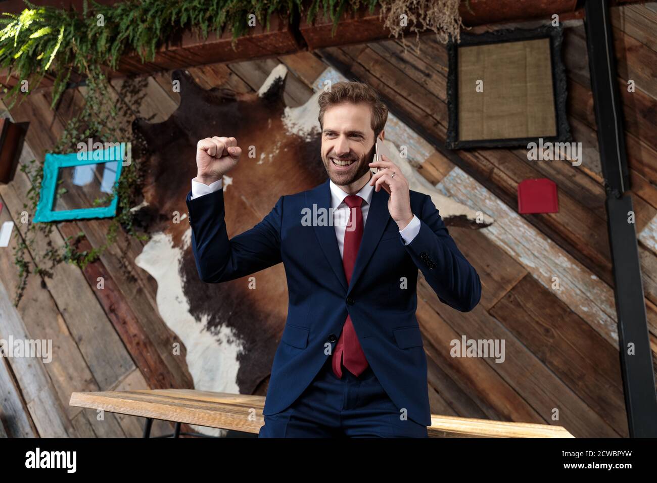 Businessman cheering at the telephone hi-res stock photography and ...