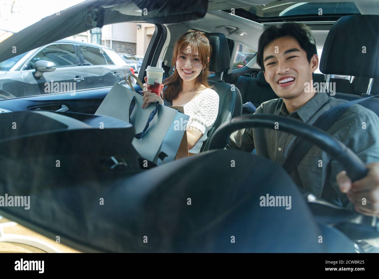 Young couple sat sitting hi-res stock photography and images - Alamy