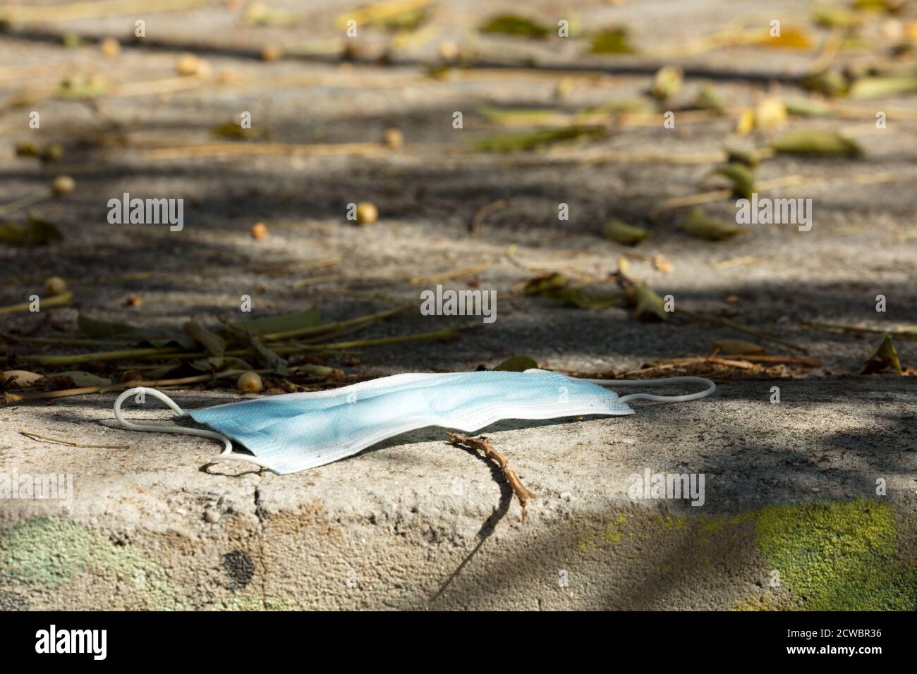 Medical protection mask lost on the ground was used. Disposable mask ...