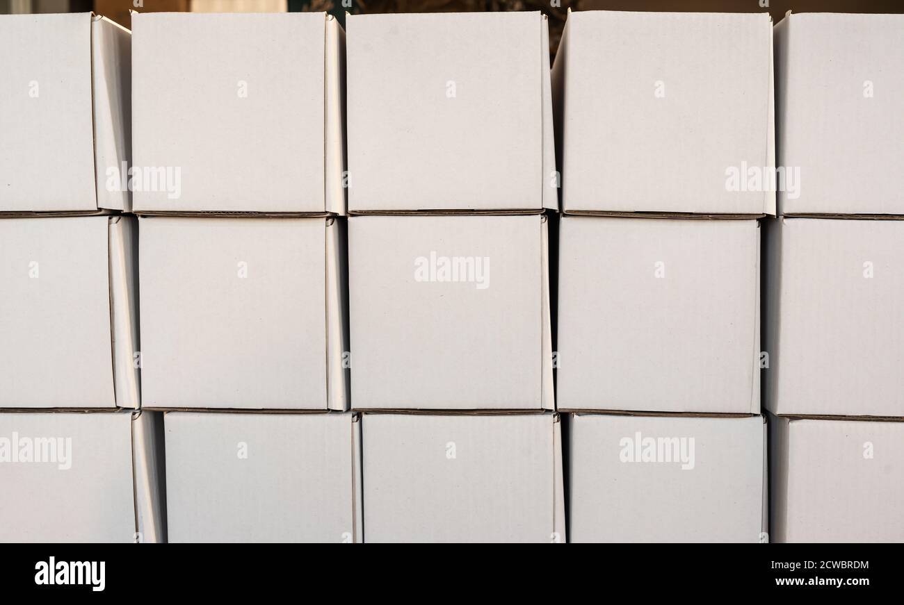 Side view of white paper boxes in rows, minimalistic design objects ...