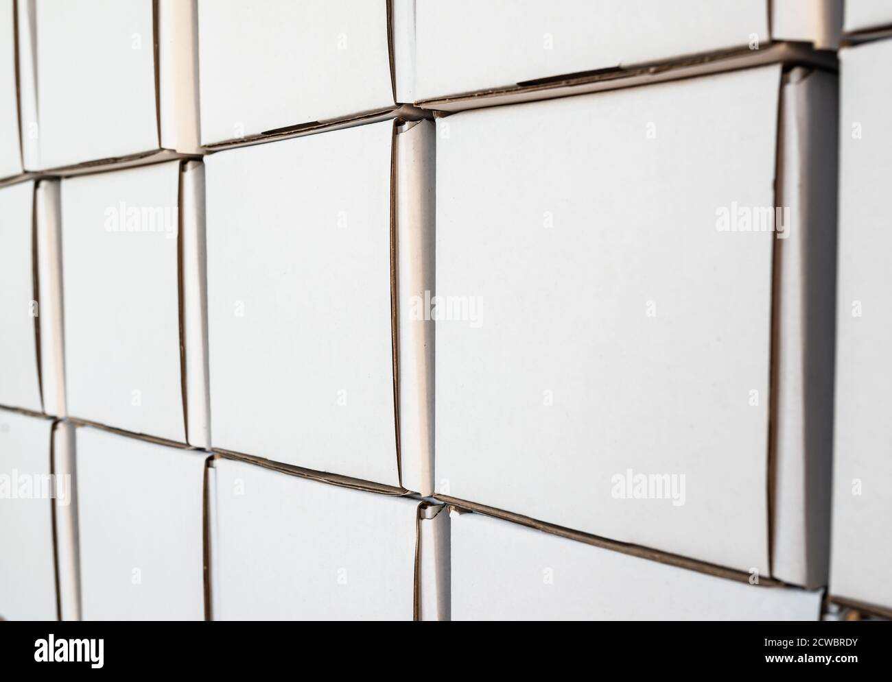 Side view of white paper boxes in rows, minimalistic design objects ...