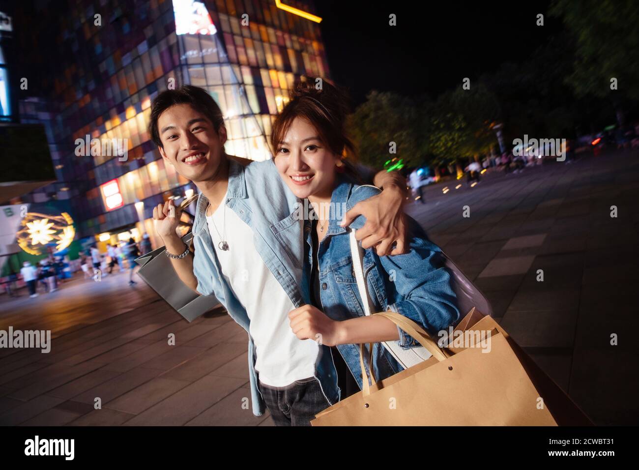Night shopping happy couples Stock Photo - Alamy