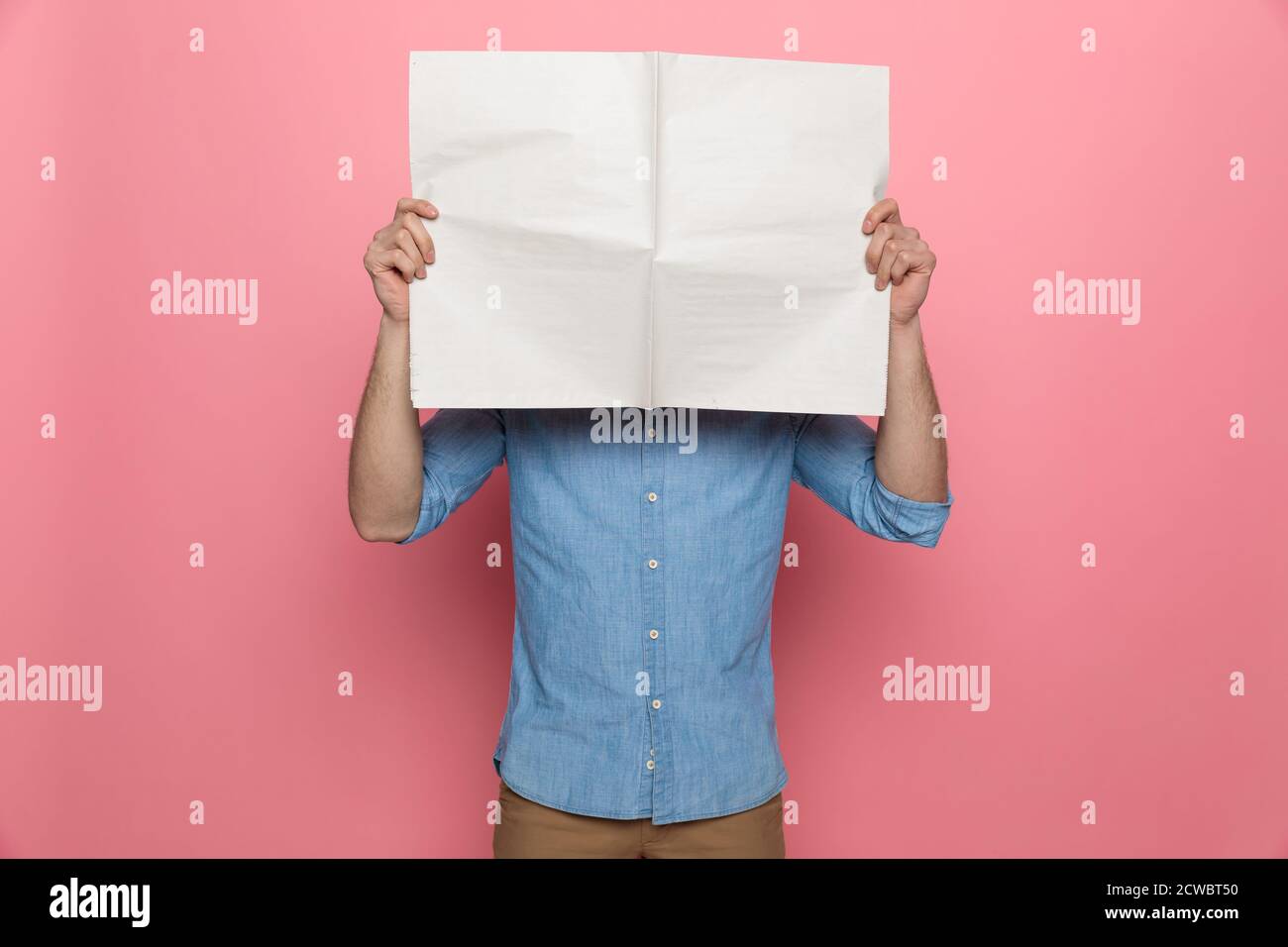 Hiding behind newspaper hi-res stock photography and images - Alamy