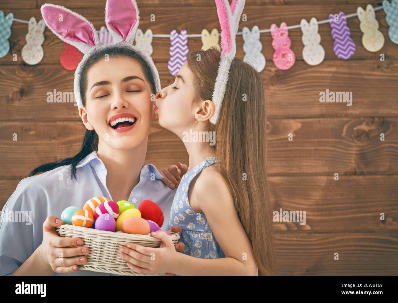 Happy holiday! Mother and her daughter with painting eggs. Family ...