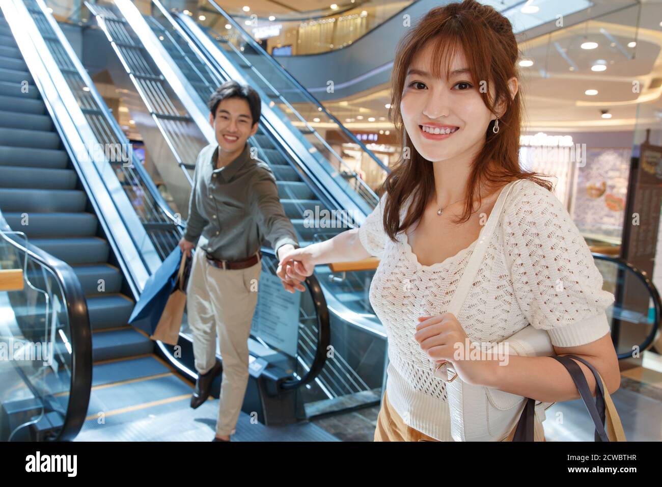 Hand in hand shopping happy couple Stock Photo - Alamy