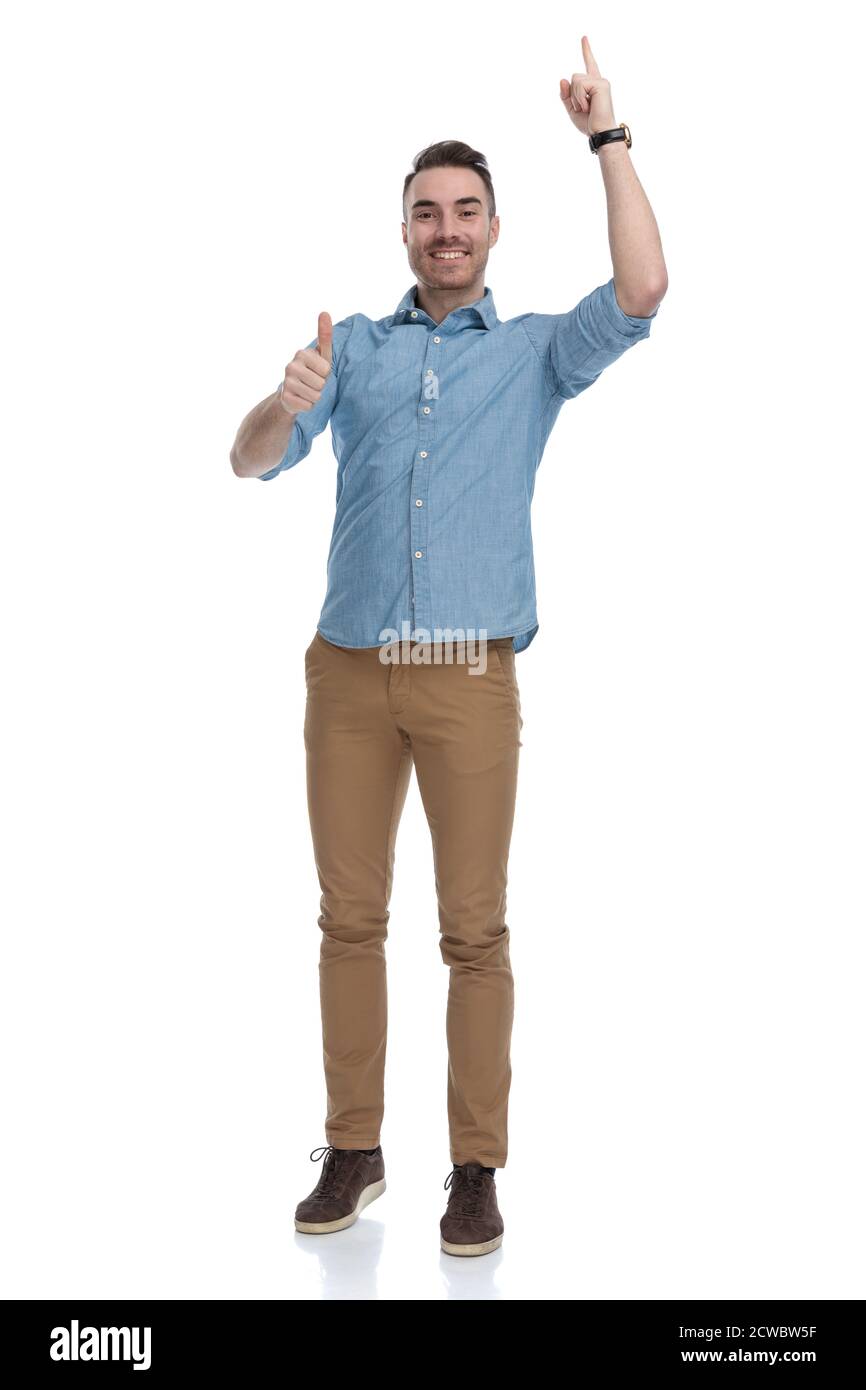 Positive casual man pointing up and gesturing ok while wearing blue ...