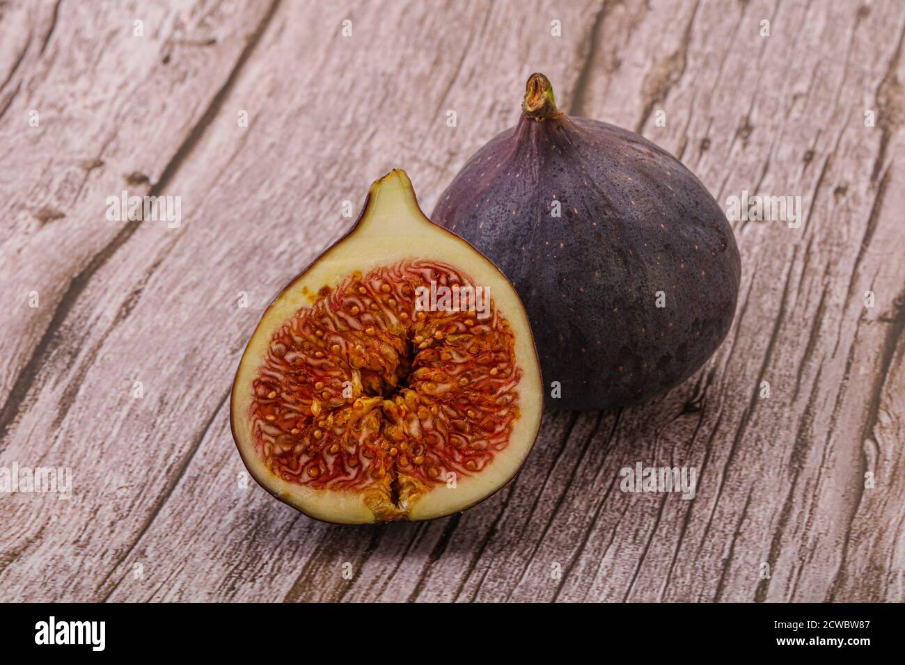 Sweet purple slice of fig fruit Stock Photo - Alamy