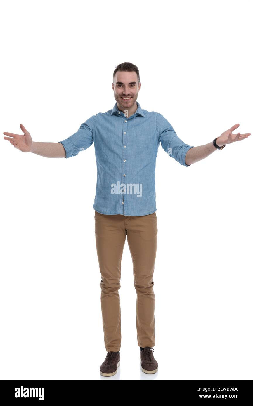 Cheerful casual man welcoming with his hands wide open while wearing ...
