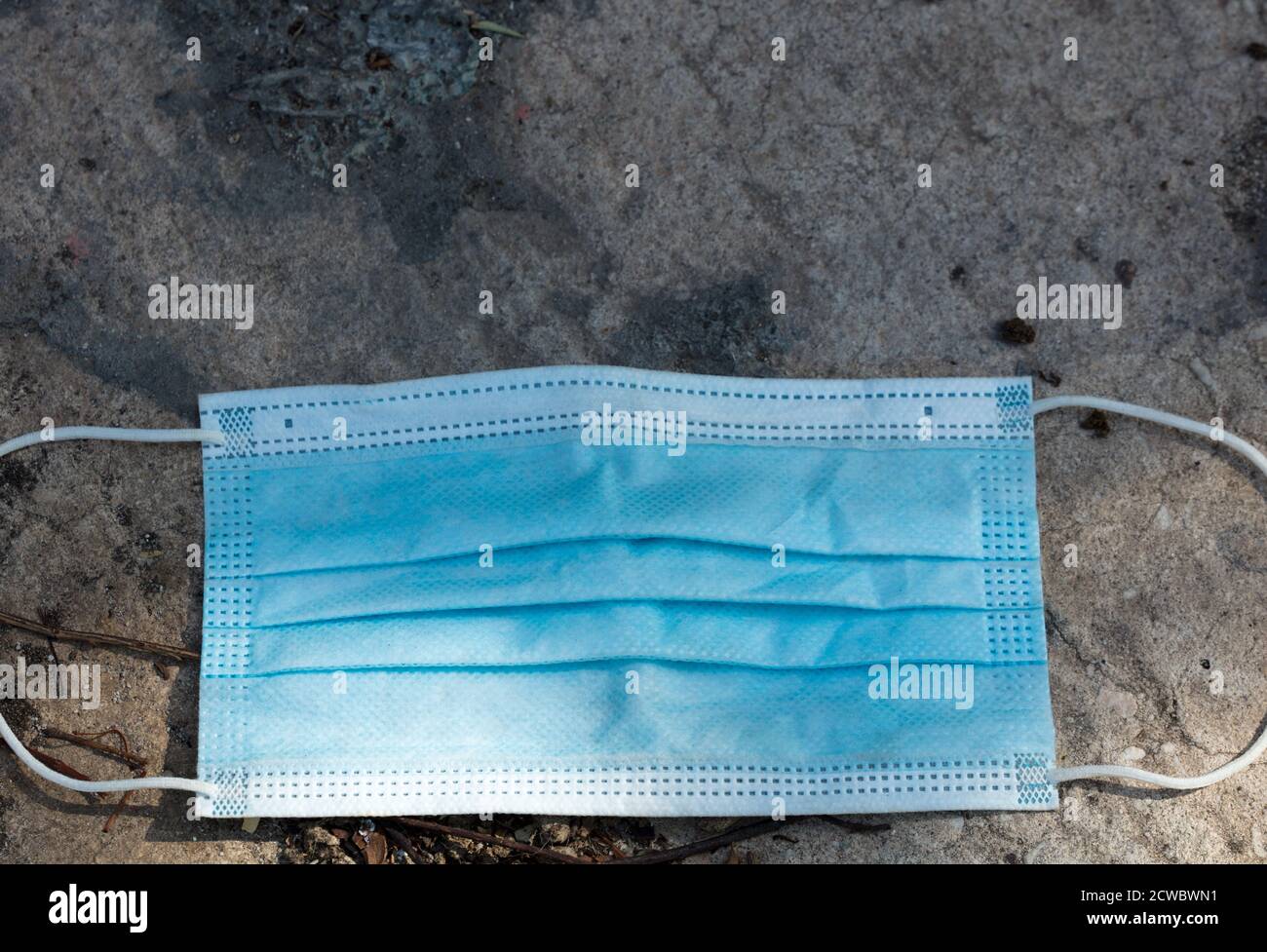 Medical protection mask lost on the ground was used. Disposable mask ...