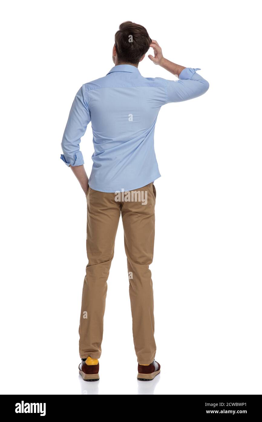 Rear view of confused casual man scratching his head while wearing ...