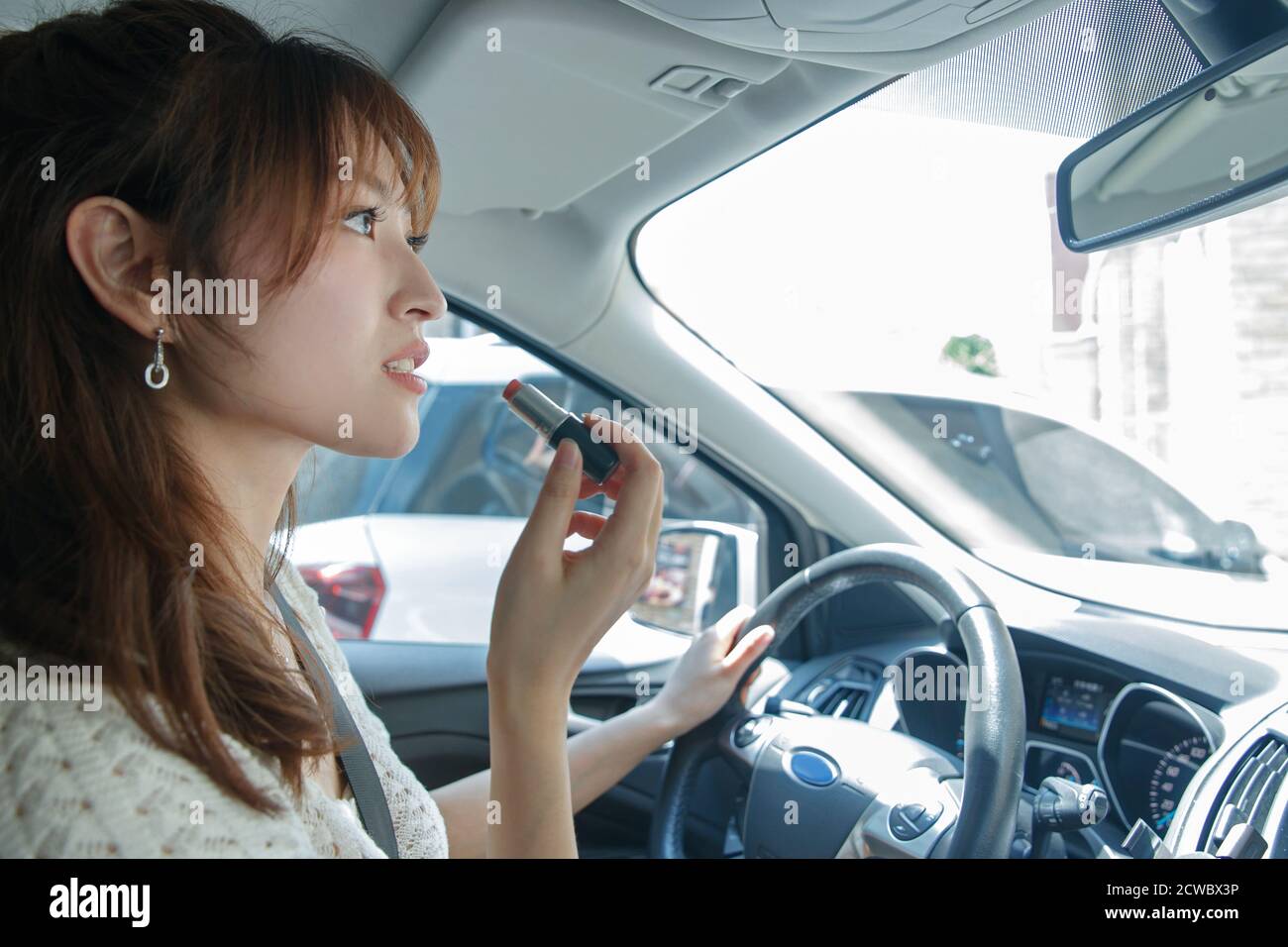 Young woman makeup in the car Stock Photo - Alamy