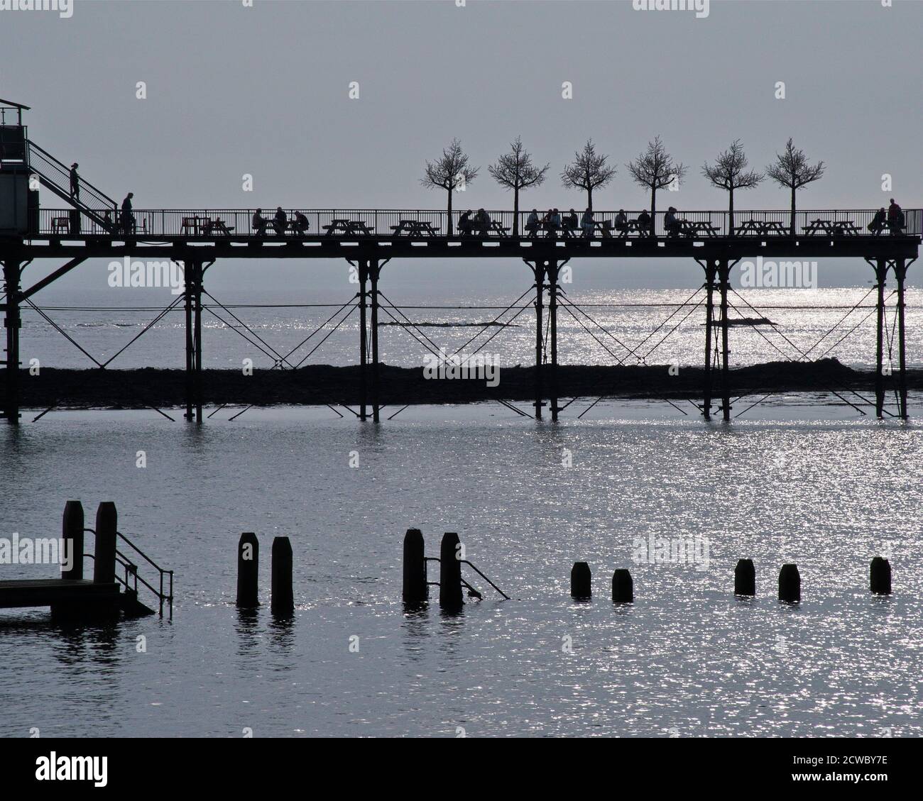 Aberystwyth Royal pier in unusual Silhouette against blue sky and sea ...