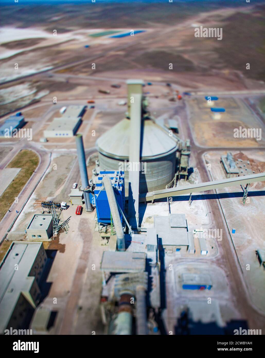 Cement plant silo and transporter conveyor. Bird-eye view. Tilt-shifted ...