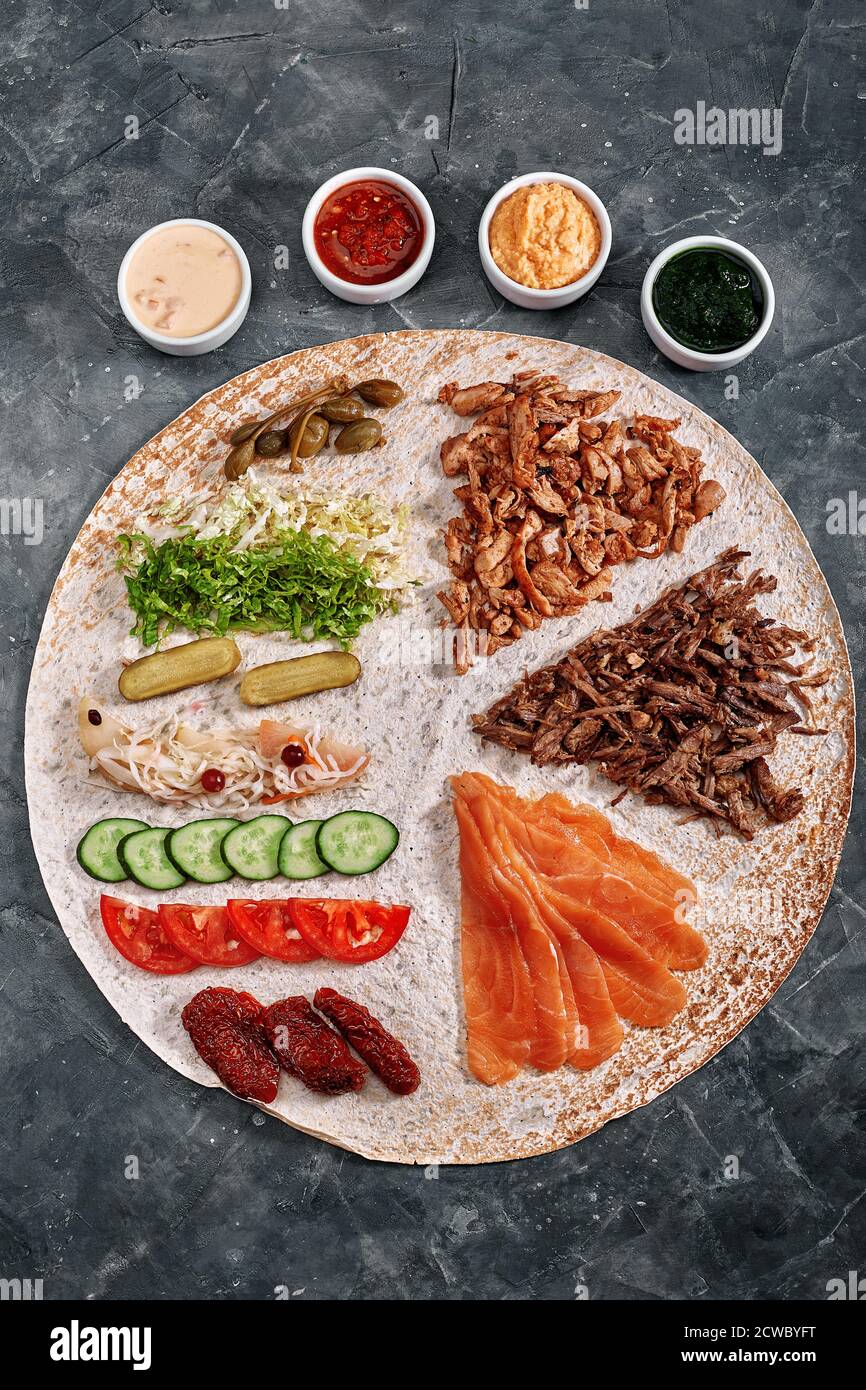 Homemade shawarma, burrito, chicken and salmon roll with vegetables and ...