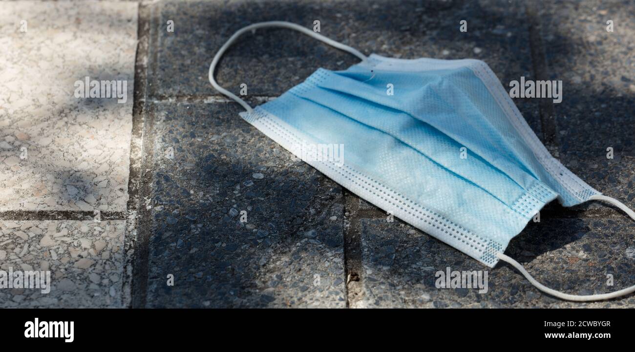 Medical protection mask lost on the ground was used. Disposable mask ...