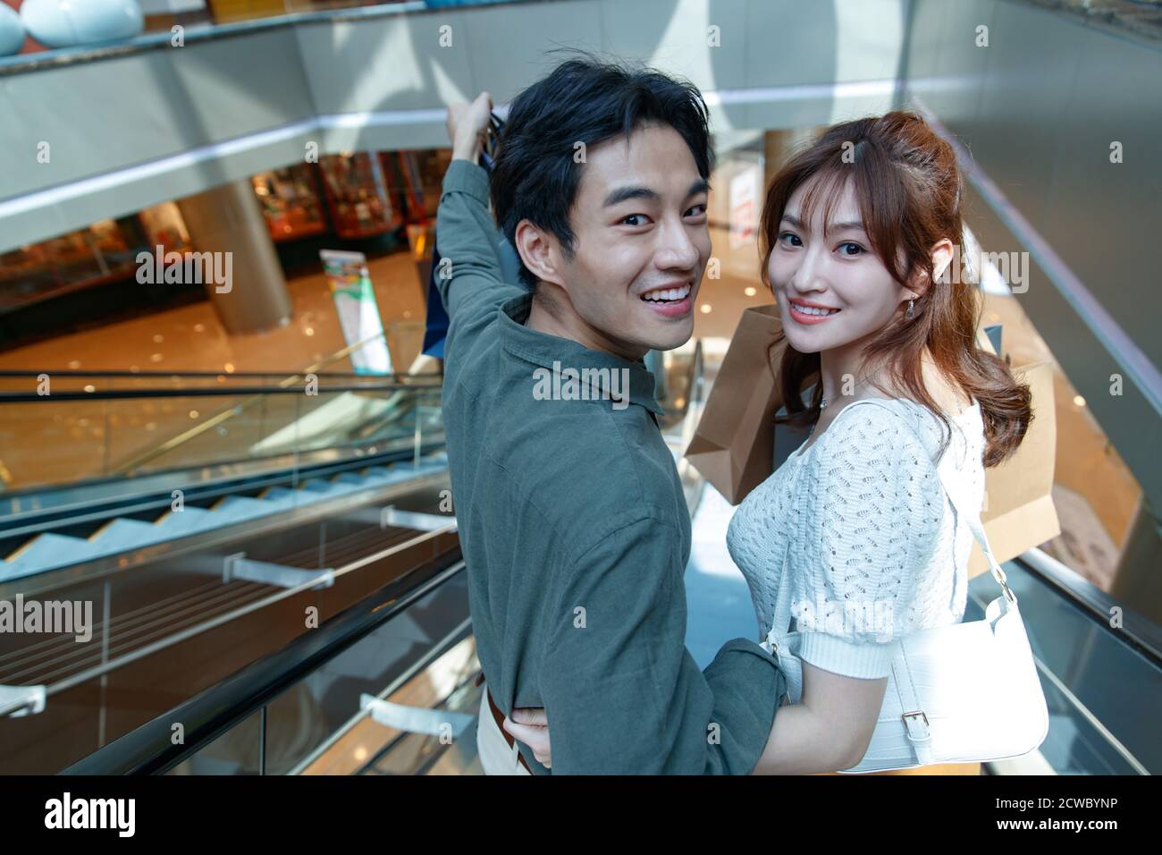 Take the lift in the market of happy couples Stock Photo - Alamy