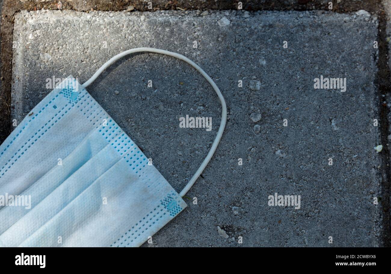 Medical protection mask lost on the ground was used. Disposable mask ...
