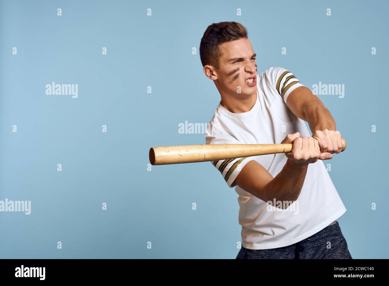baseball guy with a bat in his hand on a blue background and a combat ...