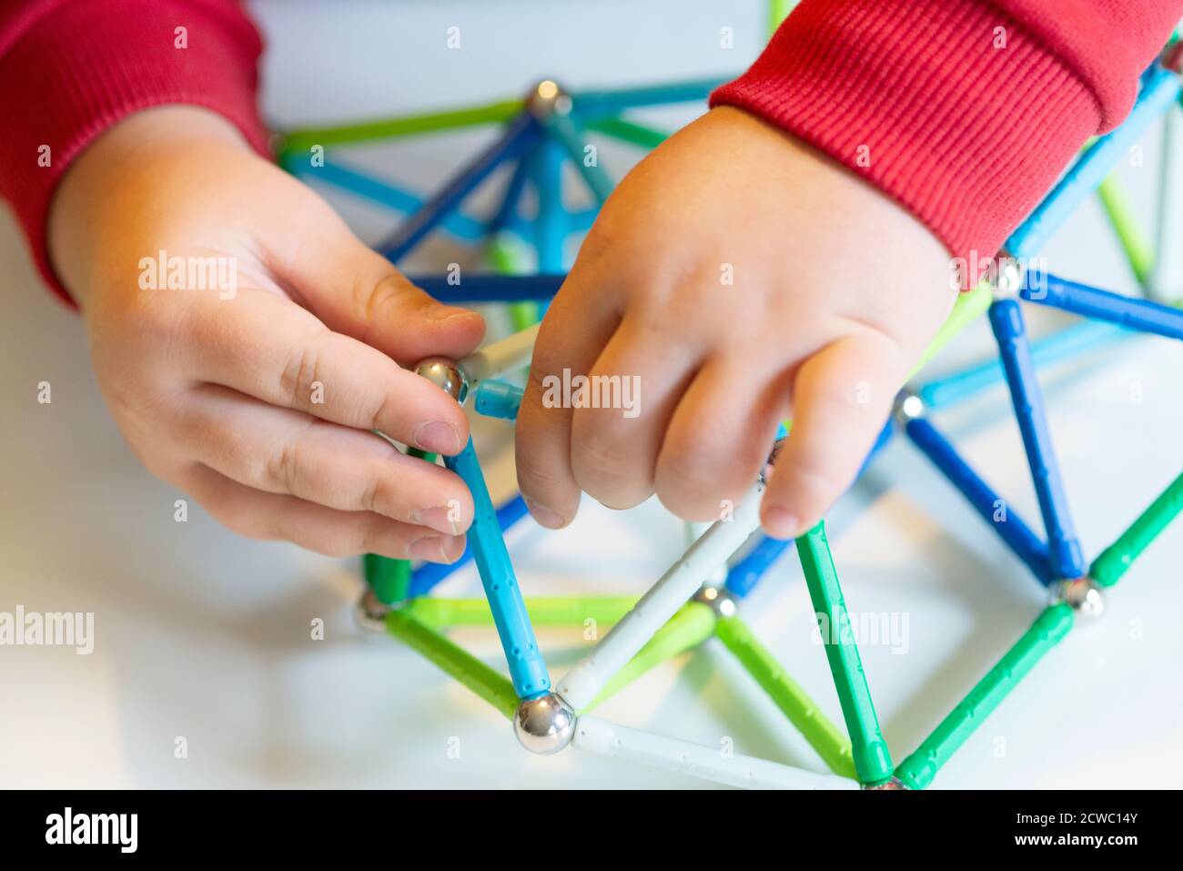 Hand Holding Magnet Toy Bars and Magnetic Balls Stock Photo - Alamy