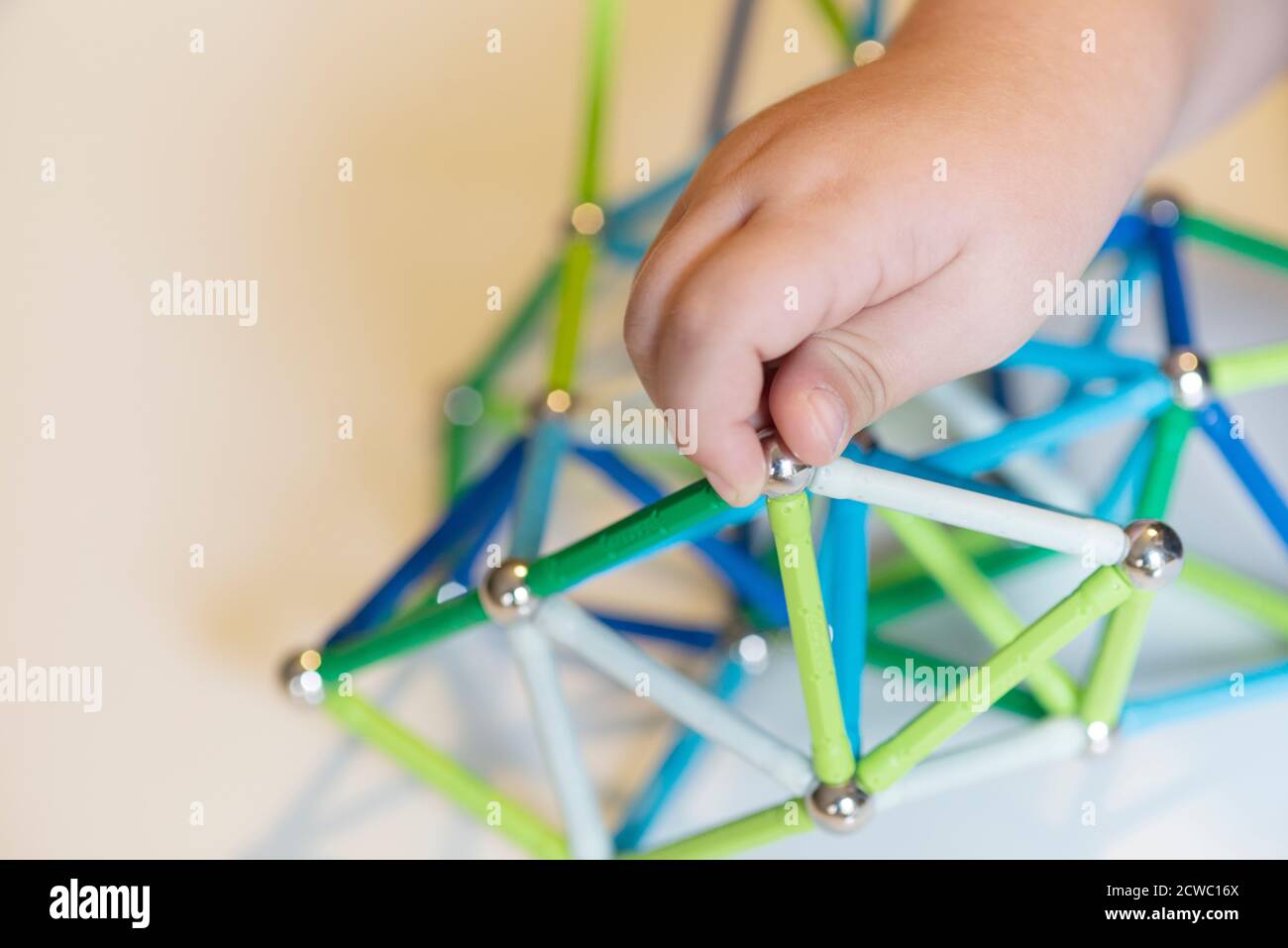 Hand Holding Magnet Toy Bars and Magnetic Balls Stock Photo - Alamy