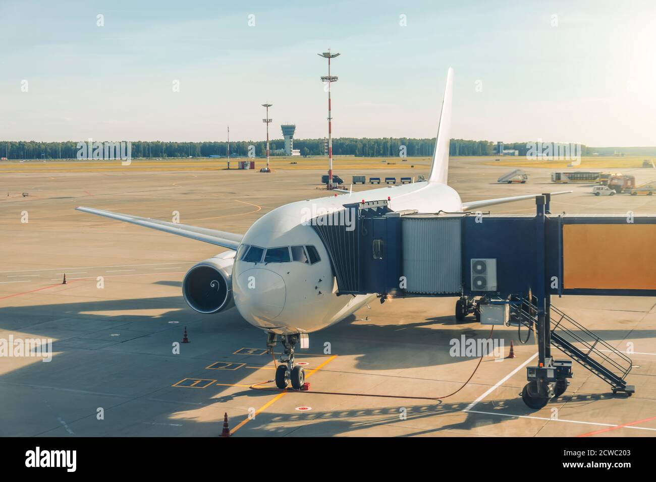 The aircraft in the parking lot is attached to the boarding bridge for ...