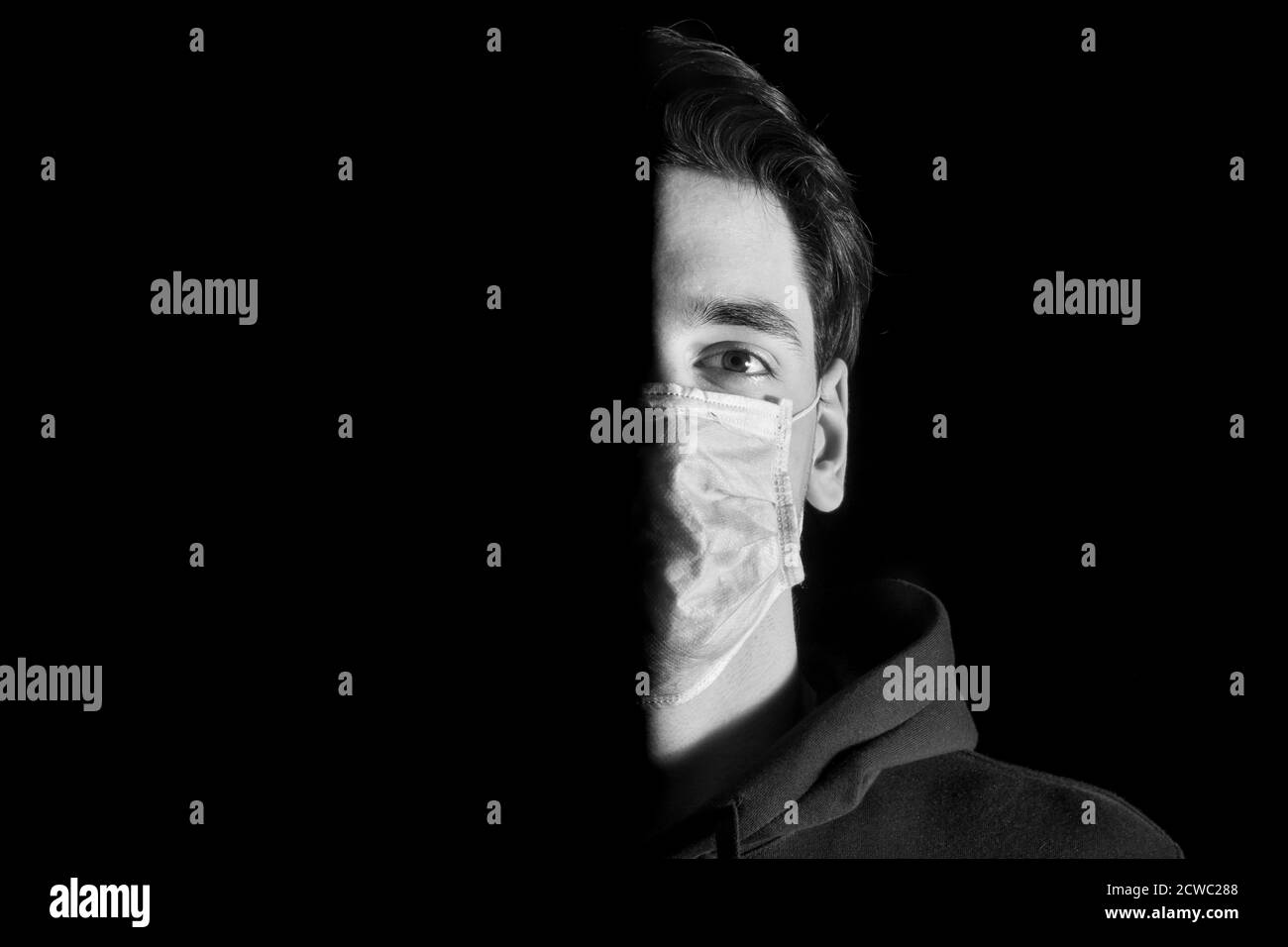 Portrait of half face with mask, hidden in the dark Stock Photo - Alamy