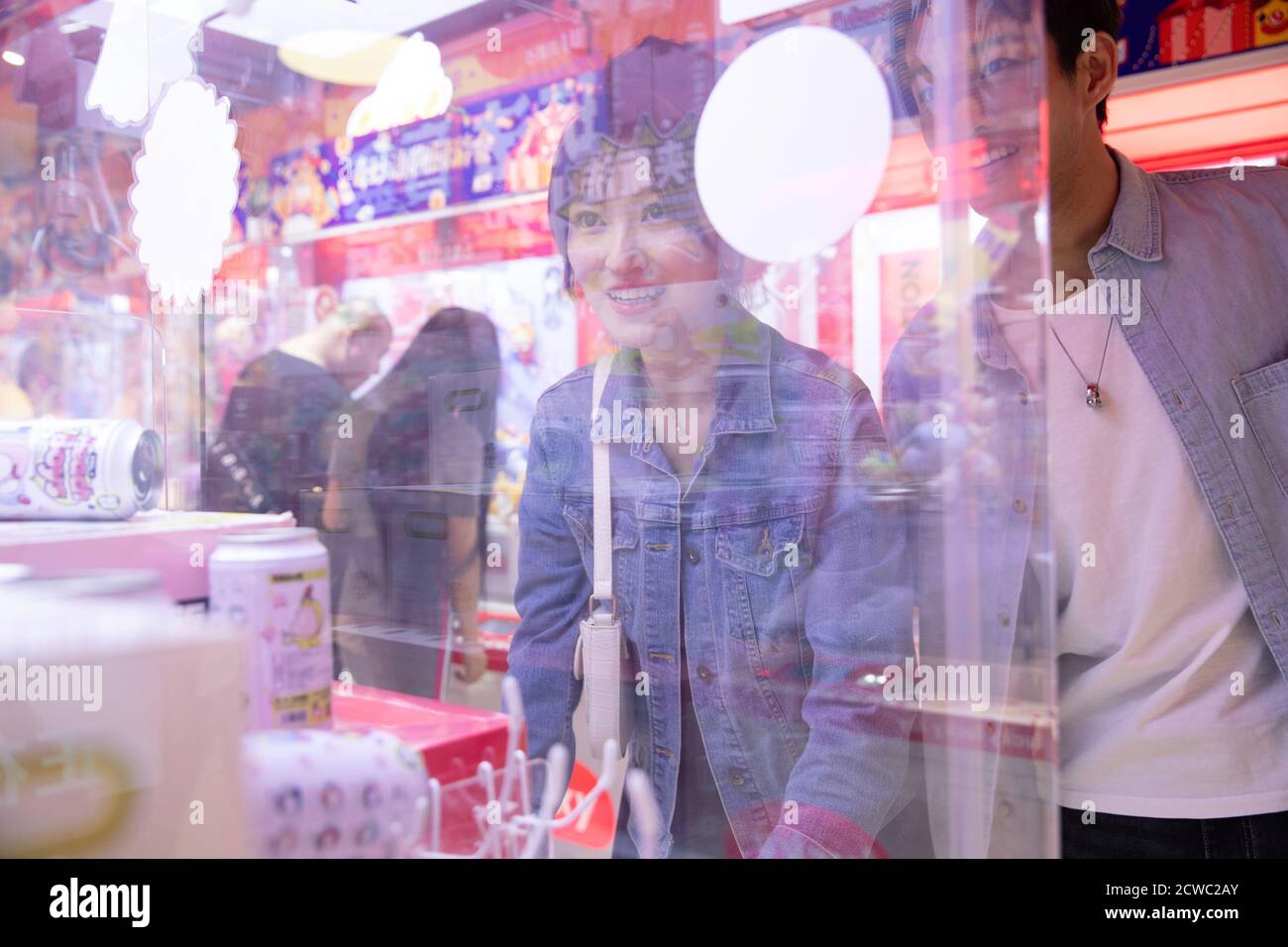 Happy couples playing catch a doll Stock Photo - Alamy