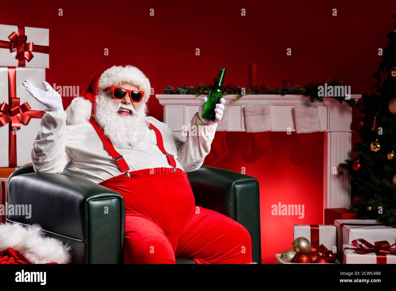 Crazy fat santa claus sit chair hold beer bottle have x-mas spirit ...