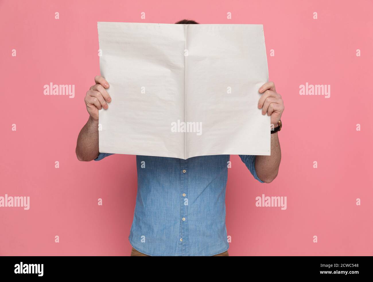 Hiding behind newspaper hi-res stock photography and images - Alamy