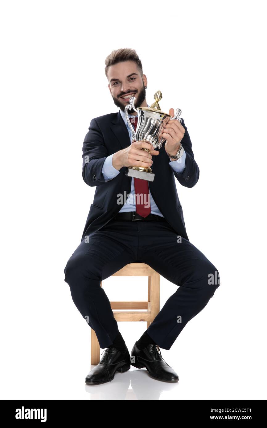 proud businessman smiling and presenting trophy, sitting isolated on ...