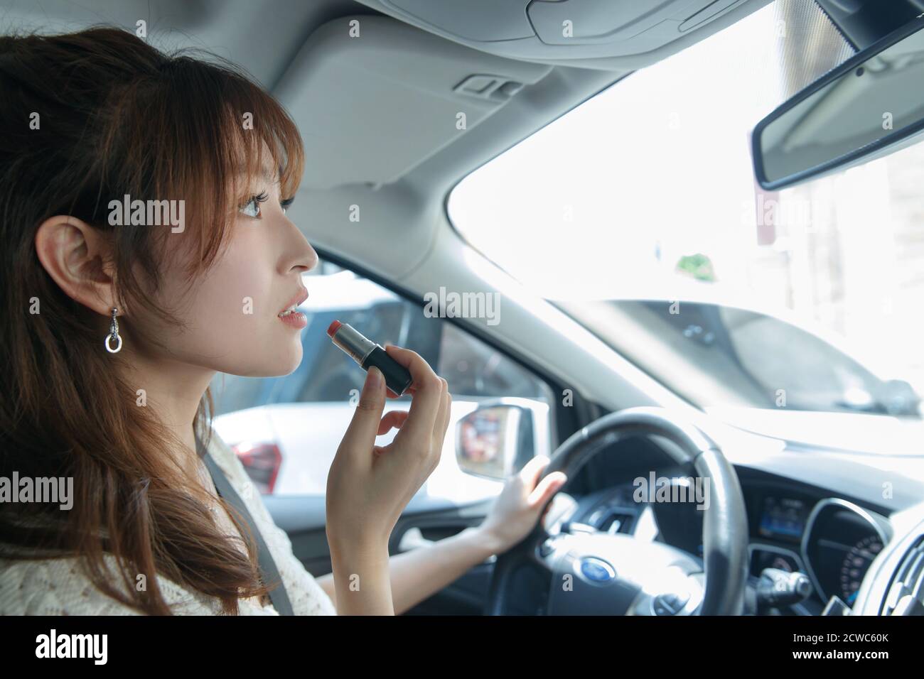 Young woman makeup in the car Stock Photo - Alamy
