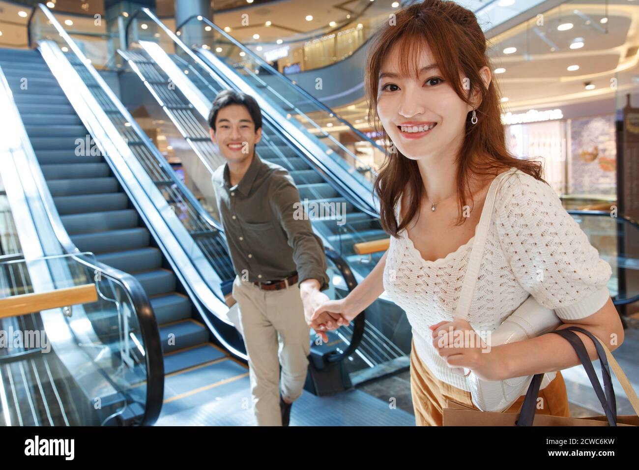 Hand in hand shopping happy couple Stock Photo - Alamy