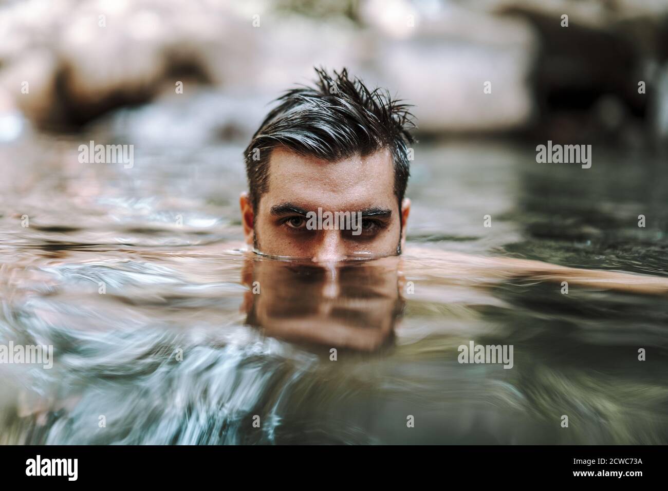 Portrait of a young male swimming in the river Stock Photo - Alamy